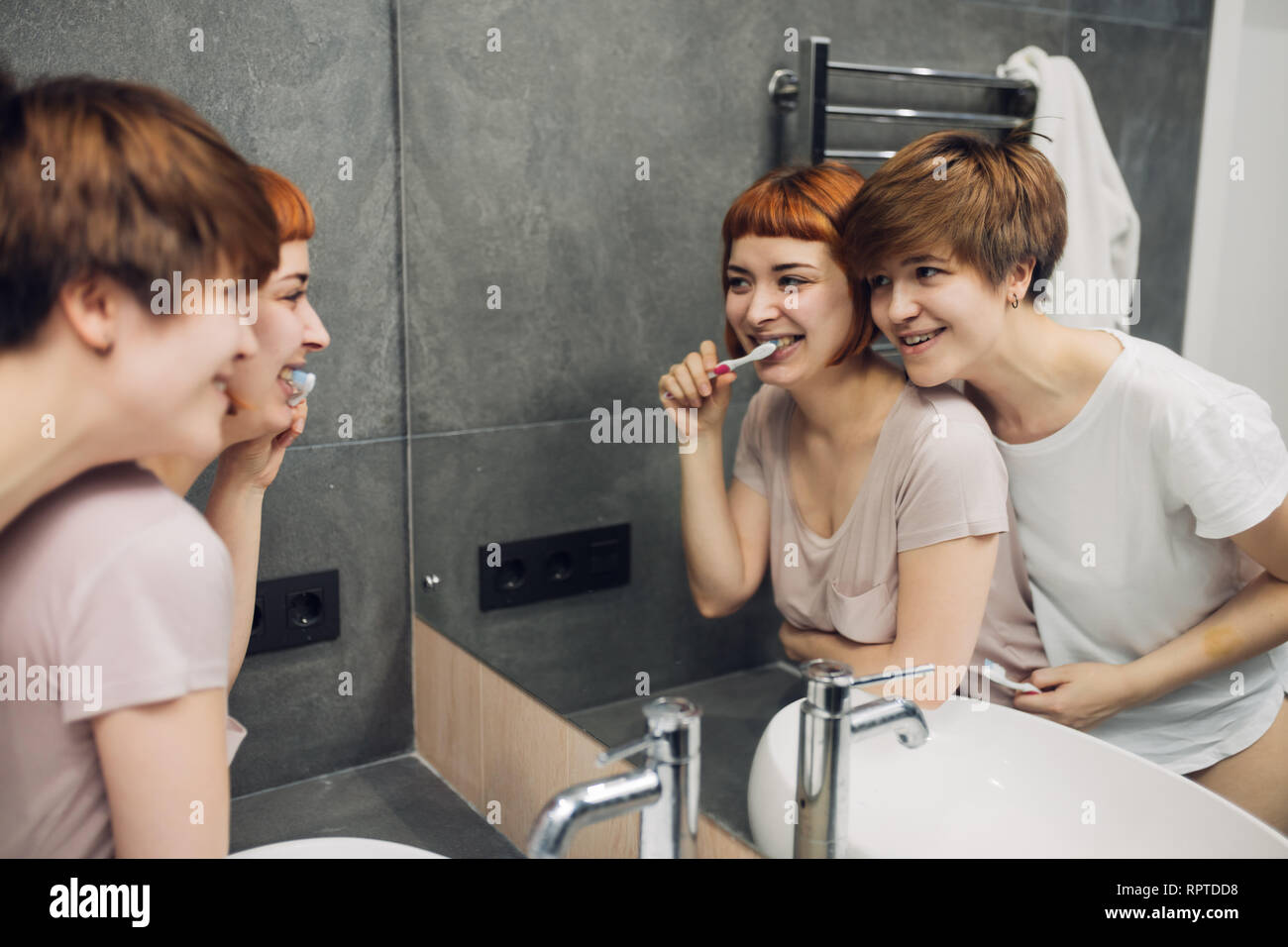 happy roommates having fun in the bathroom. spare time. lifestyle ...