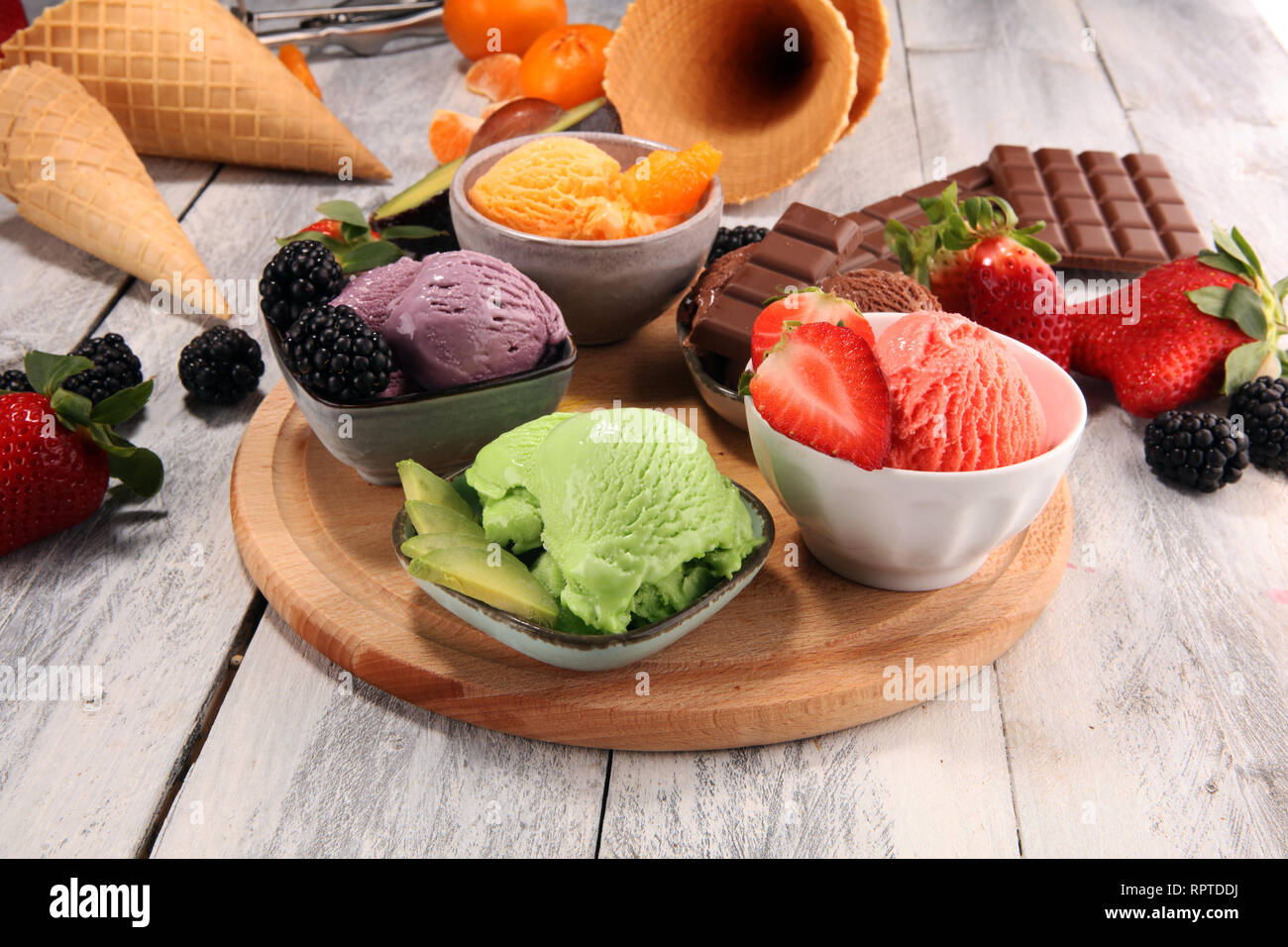 Set of ice cream scoops of different colors and flavours with berries ...