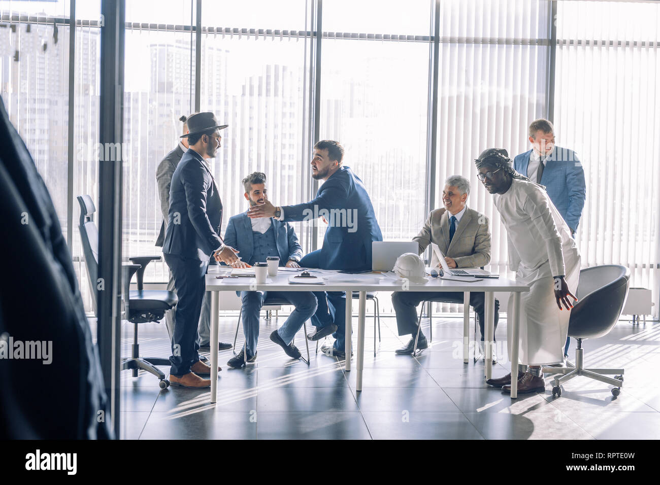 Diverse business executives discussing project sitting at conference ...