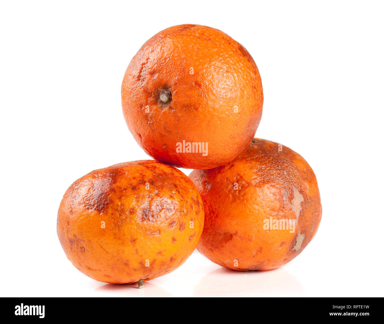 three damaged tangerine isolated on white background Stock Photo - Alamy