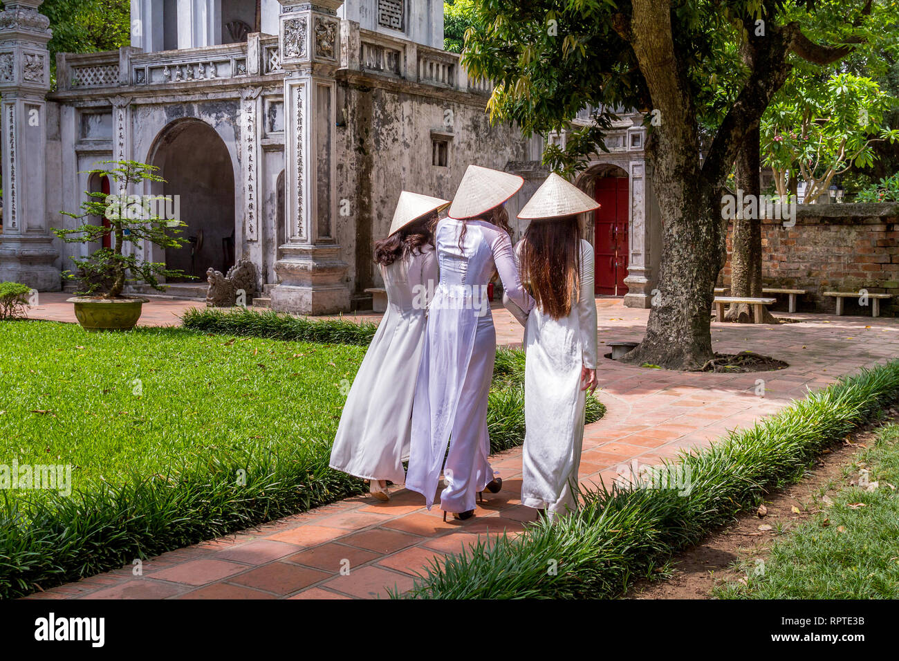 Young Vietnamese women wearing the traditional dress Ao Dai and the ...