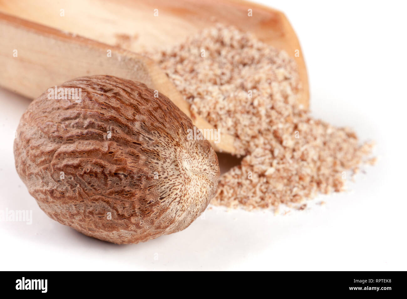 nutmeg with powder in a scoop isolated on white background Stock Photo ...