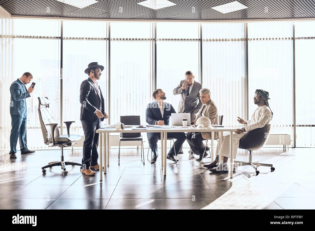 two sucessful firms are discussinga contract in the office building ...