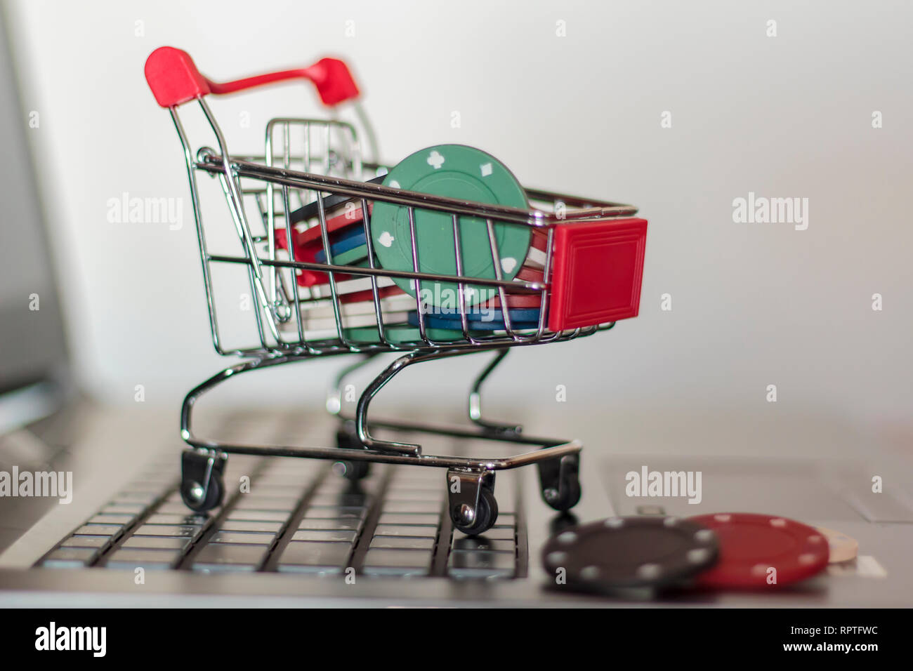 Poker chips in a shopping cart on a computer. Online Gambling addiction ...