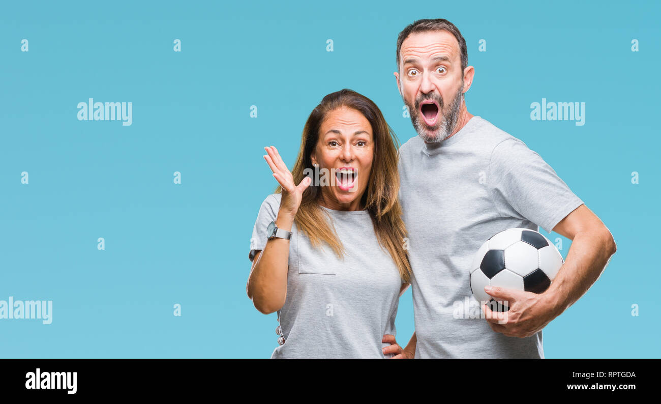 Middle age hispanic couple holding football soccer ball over isolated ...