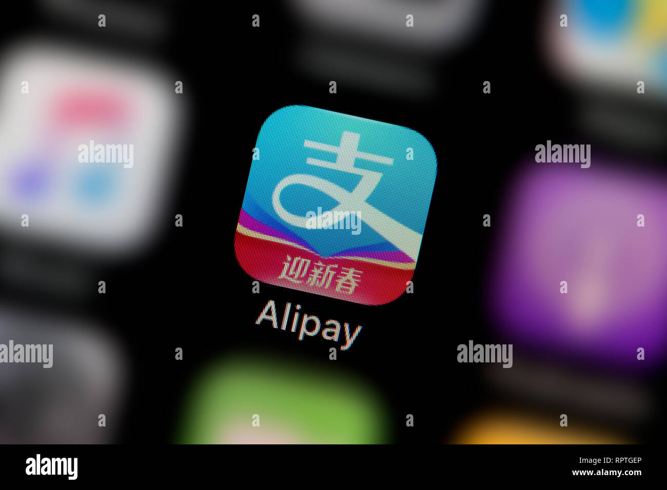 A close-up shot of the Alipay app icon, as seen on the screen of a ...