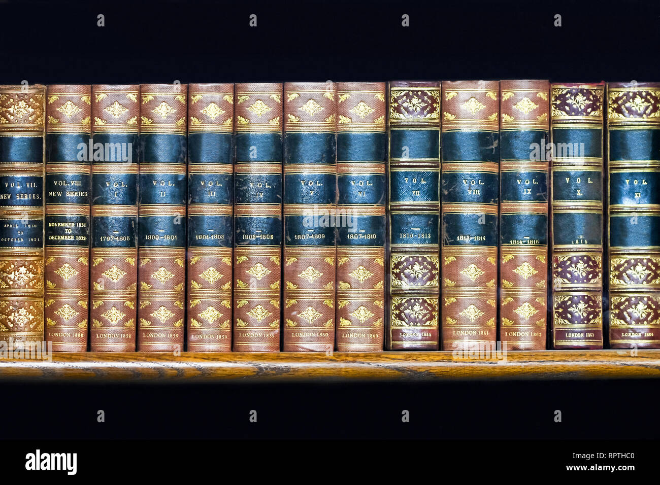 Large volume of old books at rack Stock Photo - Alamy