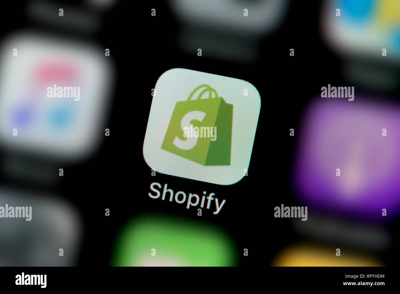 A close-up shot of the Shopify app icon, as seen on the screen of a ...