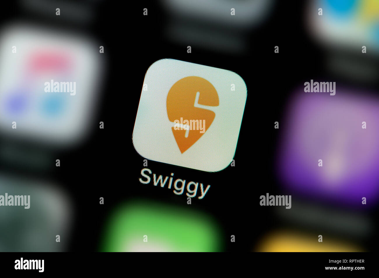 A close-up shot of the Swiggy app icon, as seen on the screen of a ...