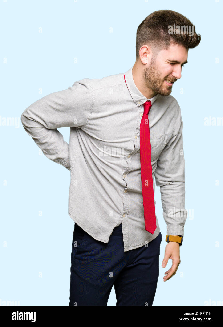 Young handsome business man Suffering of backache, touching back with ...