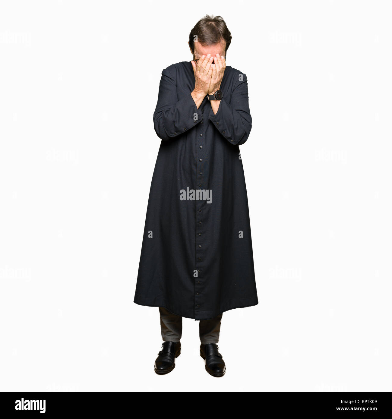 Middle age priest man wearing catholic robe with sad expression ...