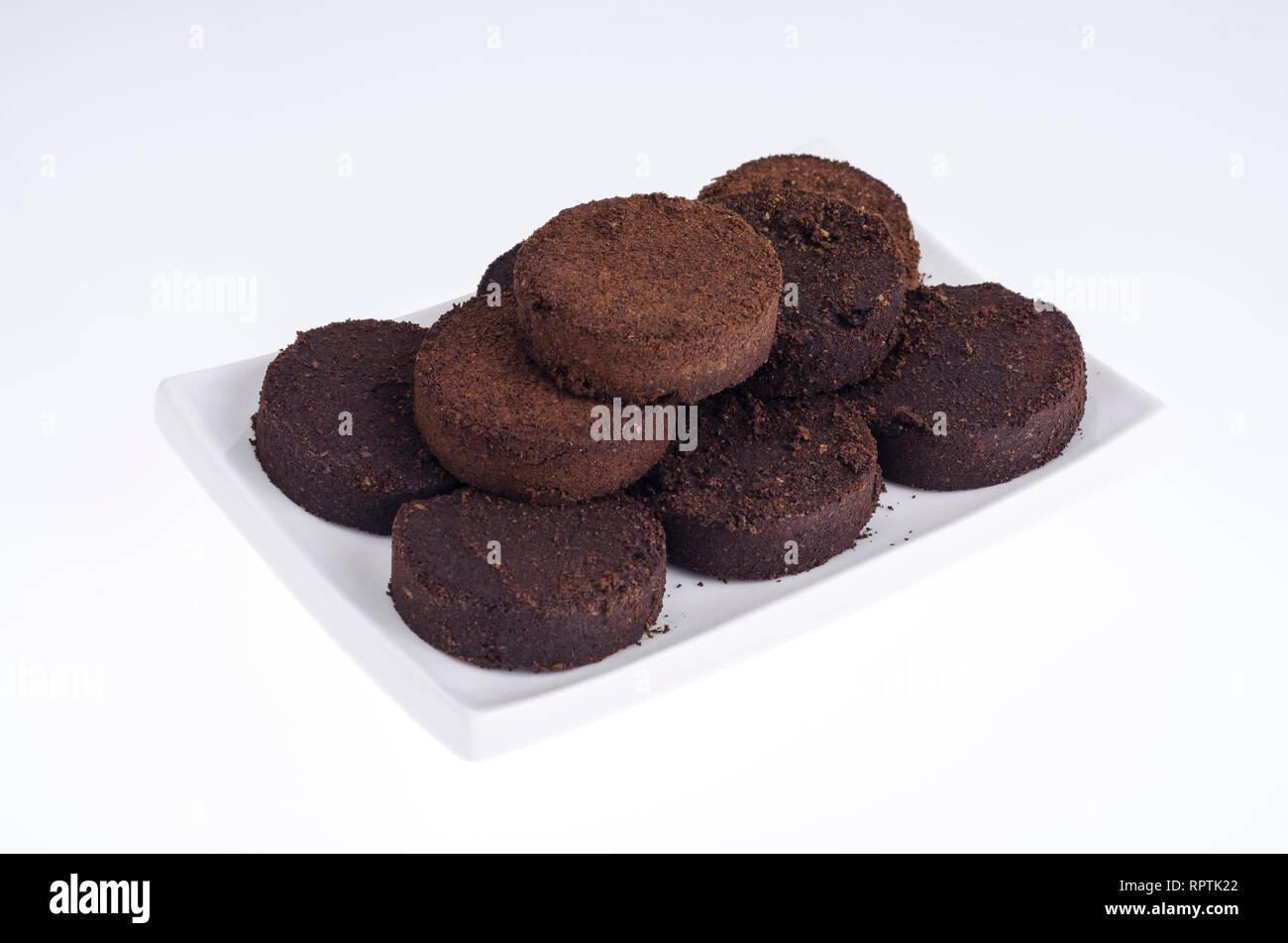 Pressed waste coffee beans on white background. Studio Photo Stock ...