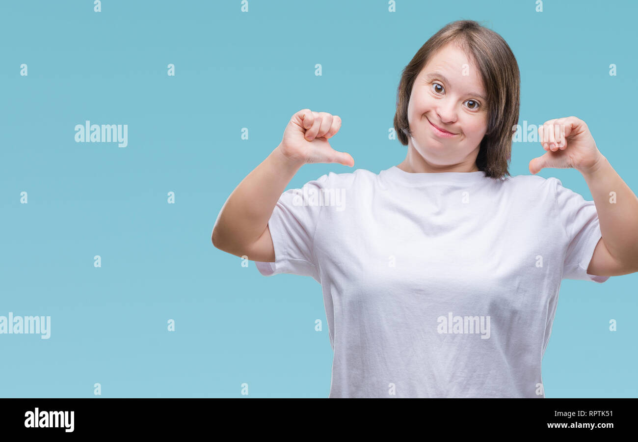Young adult woman with down syndrome over isolated background looking ...