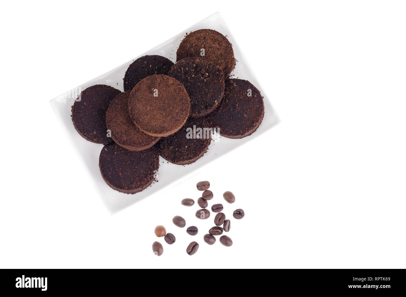 Pressed waste coffee beans on white background. Studio Photo Stock ...