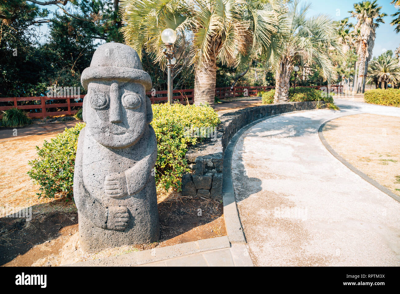 Dol hareubang stone grandpa with tropical palm trees at Daepo ...