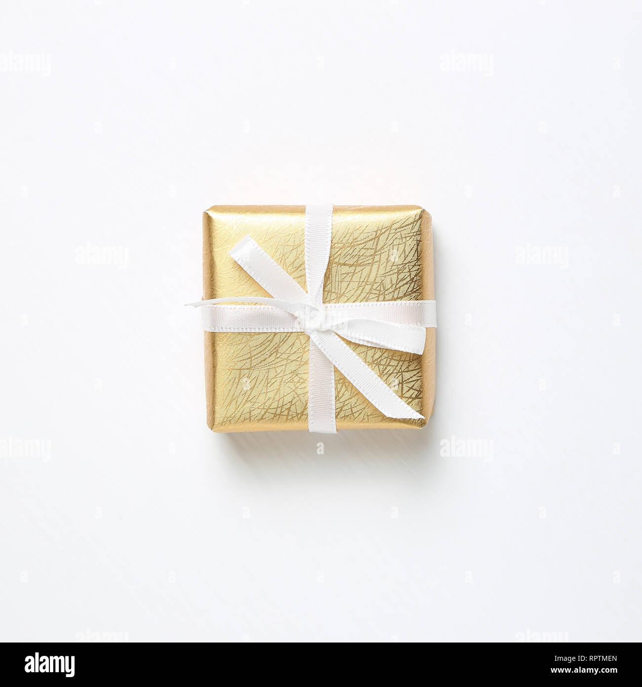 Gold gift box isolated on white background Stock Photo - Alamy
