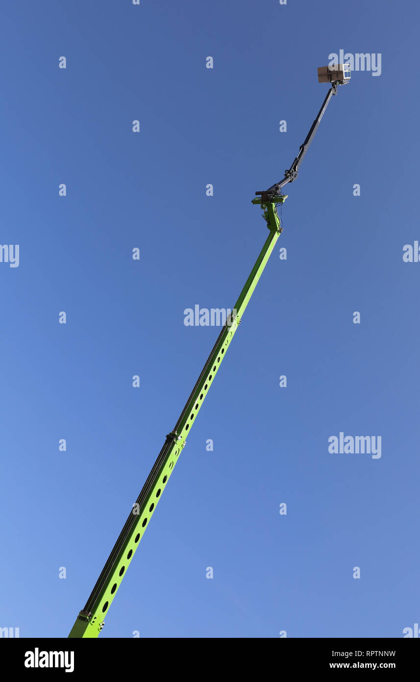 very high aerial platform with the long mechanical arm to perform work ...