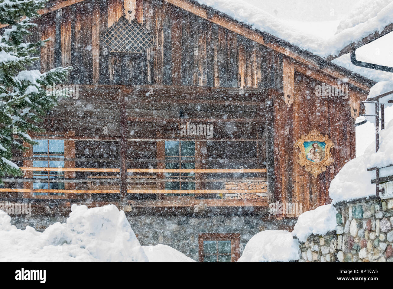While it snows. Along the streets of the ancient village of Sappada ...