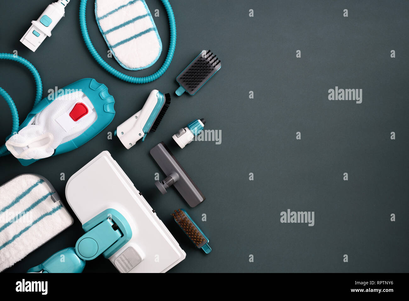 Kit of modern professional steam cleaners on grey background. Top view ...