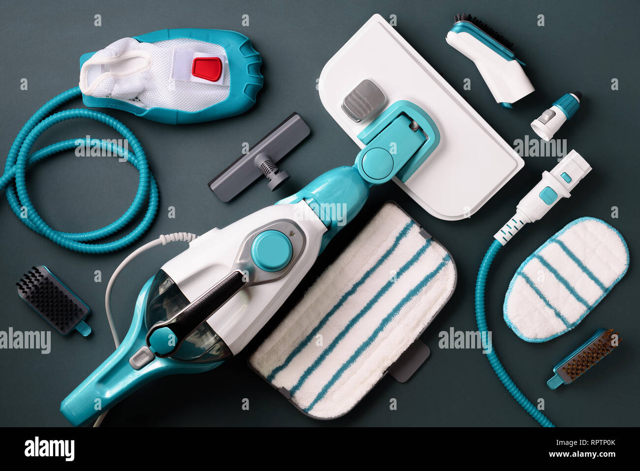 Kit of modern professional steam cleaners on grey background. Top view ...