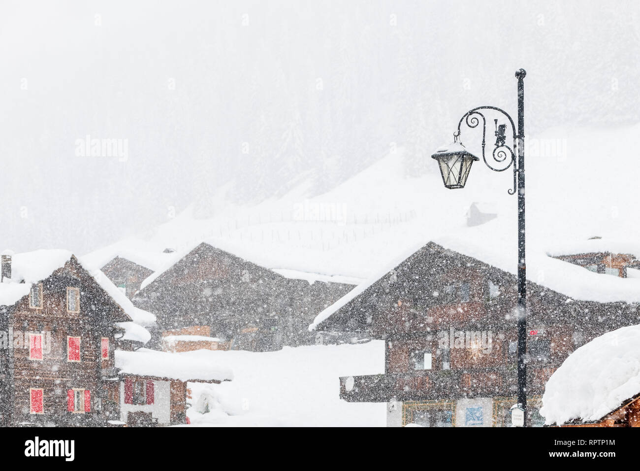 While it snows. Along the streets of the ancient village of Sappada ...