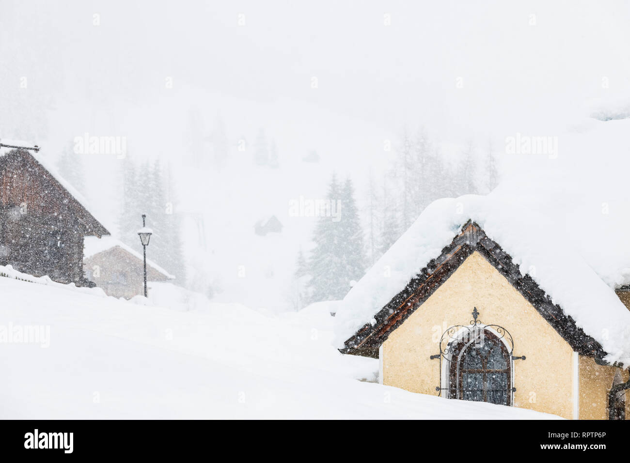 While it snows. Along the streets of the ancient village of Sappada ...