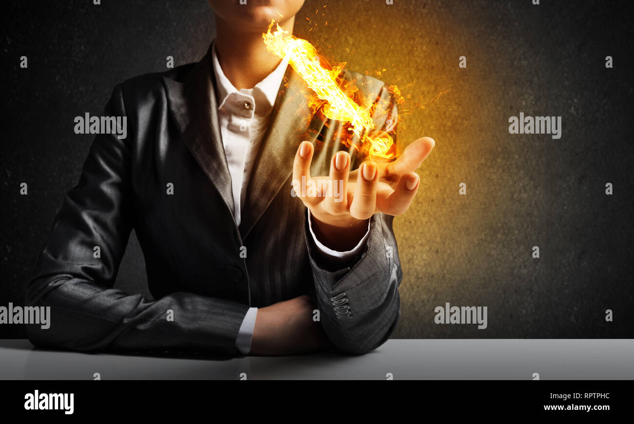 Cropped image of businessman in suit presenting flaming exclamation ...