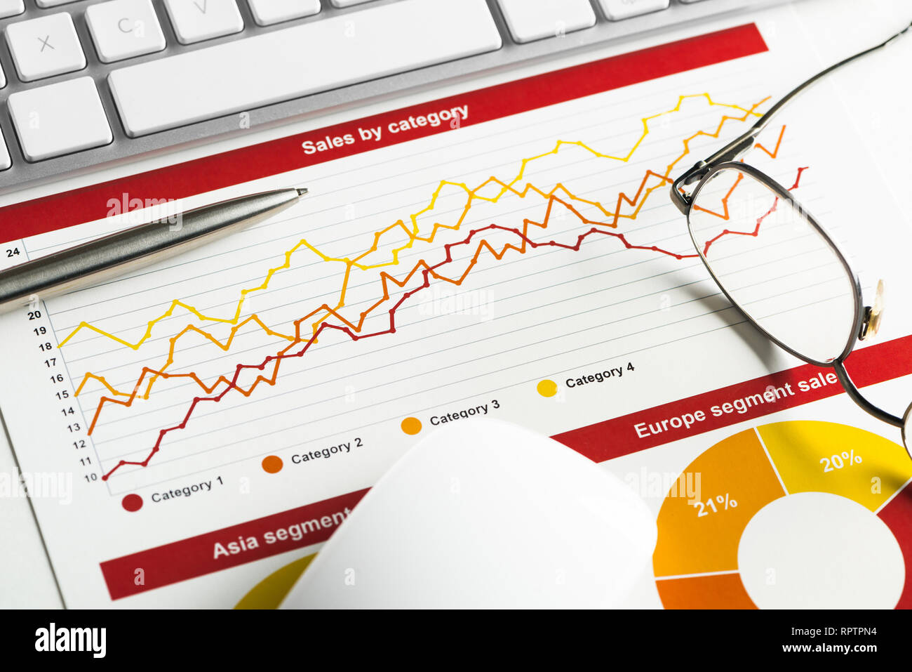 Business workplace with keyboard mouse and papers with graphs and ...