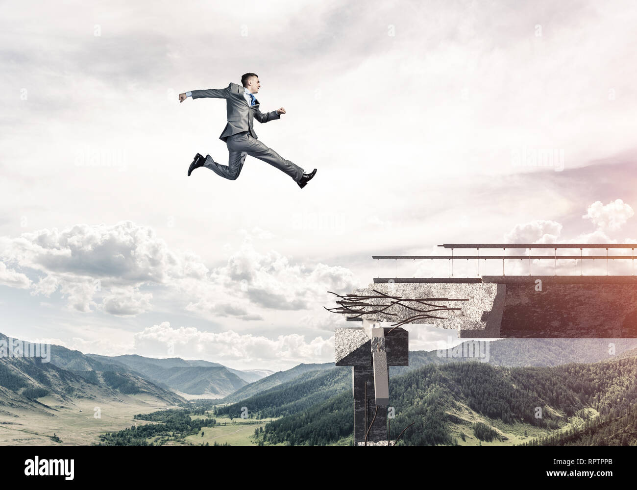 Businessman jumping over huge gap in concrete bridge as symbol of ...
