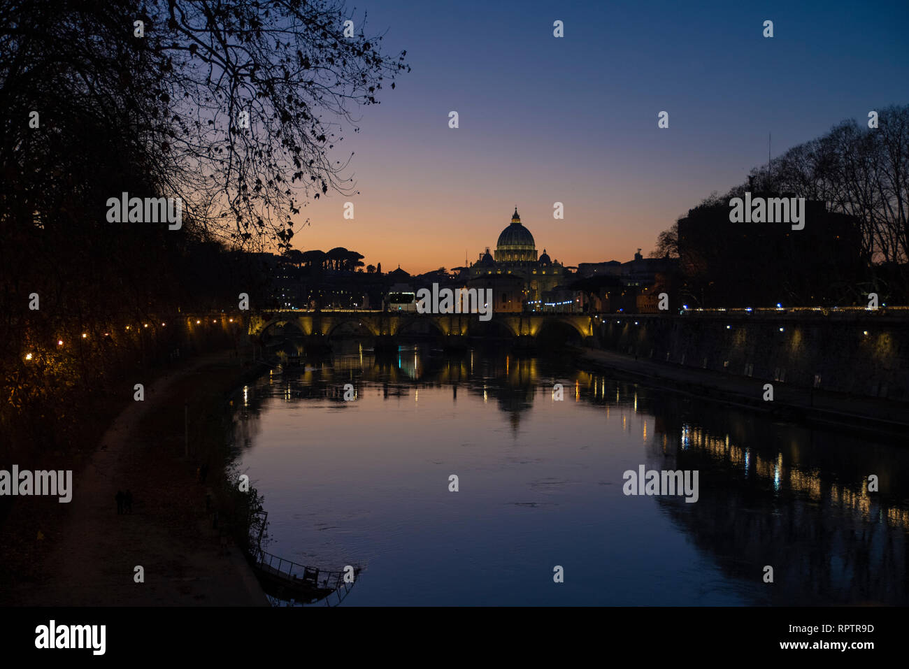 view from the tiber river of St. Peter's Basilica at sunset, Vatican ...