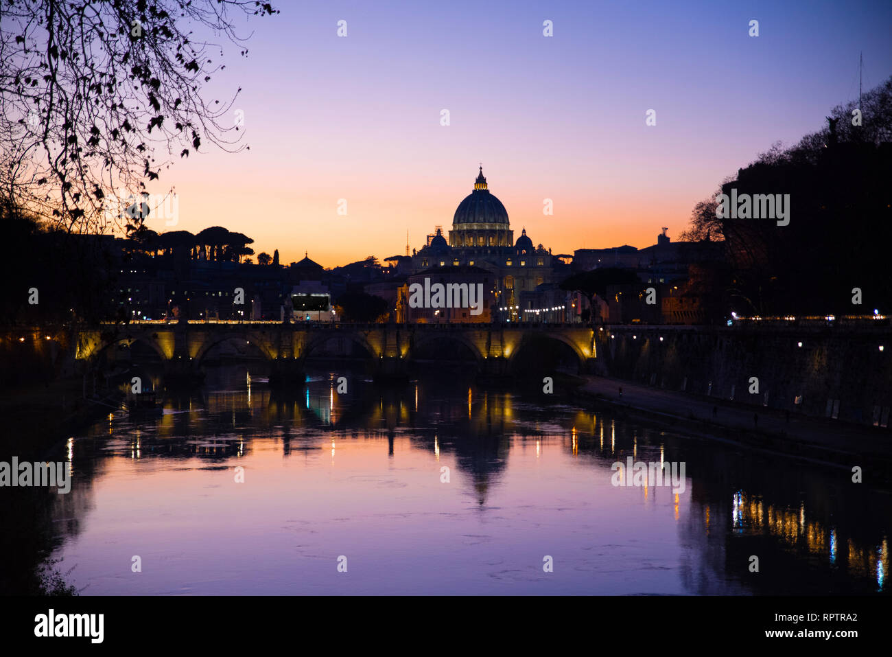 view from the tiber river of St. Peter's Basilica at sunset, Vatican ...
