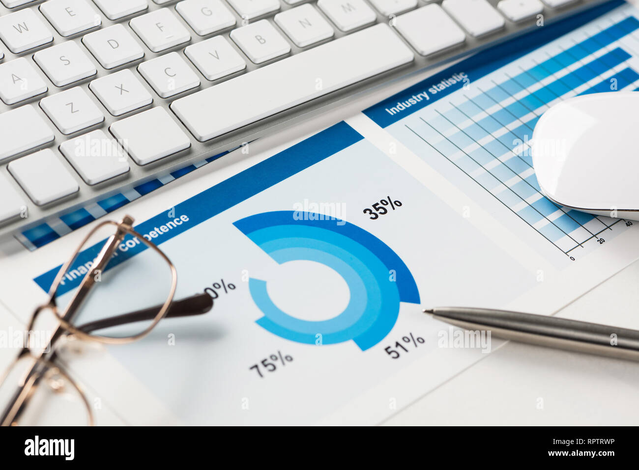 Business workplace with keyboard mouse and papers with graphs and ...