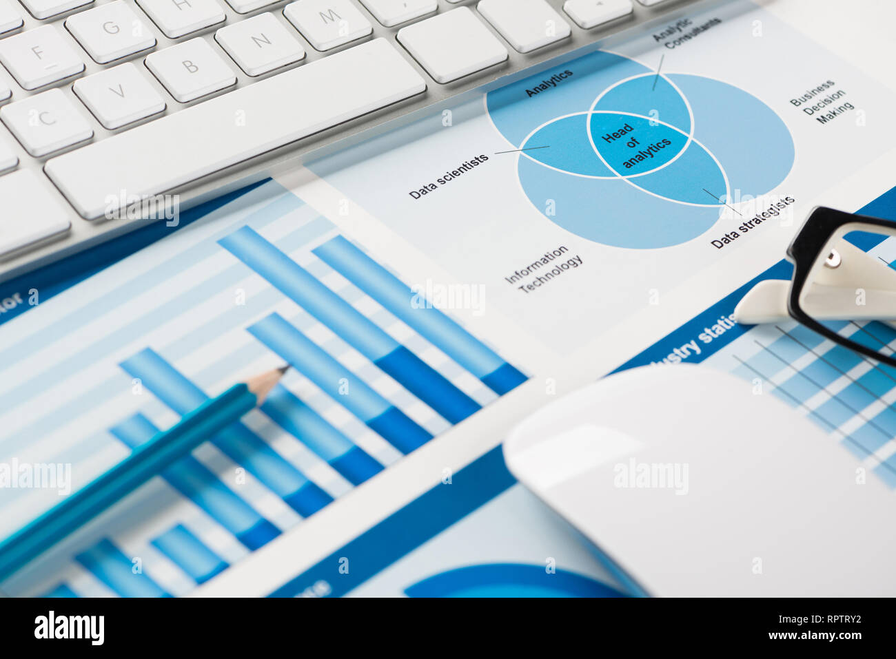 Business workplace with keyboard mouse and papers with graphs and ...