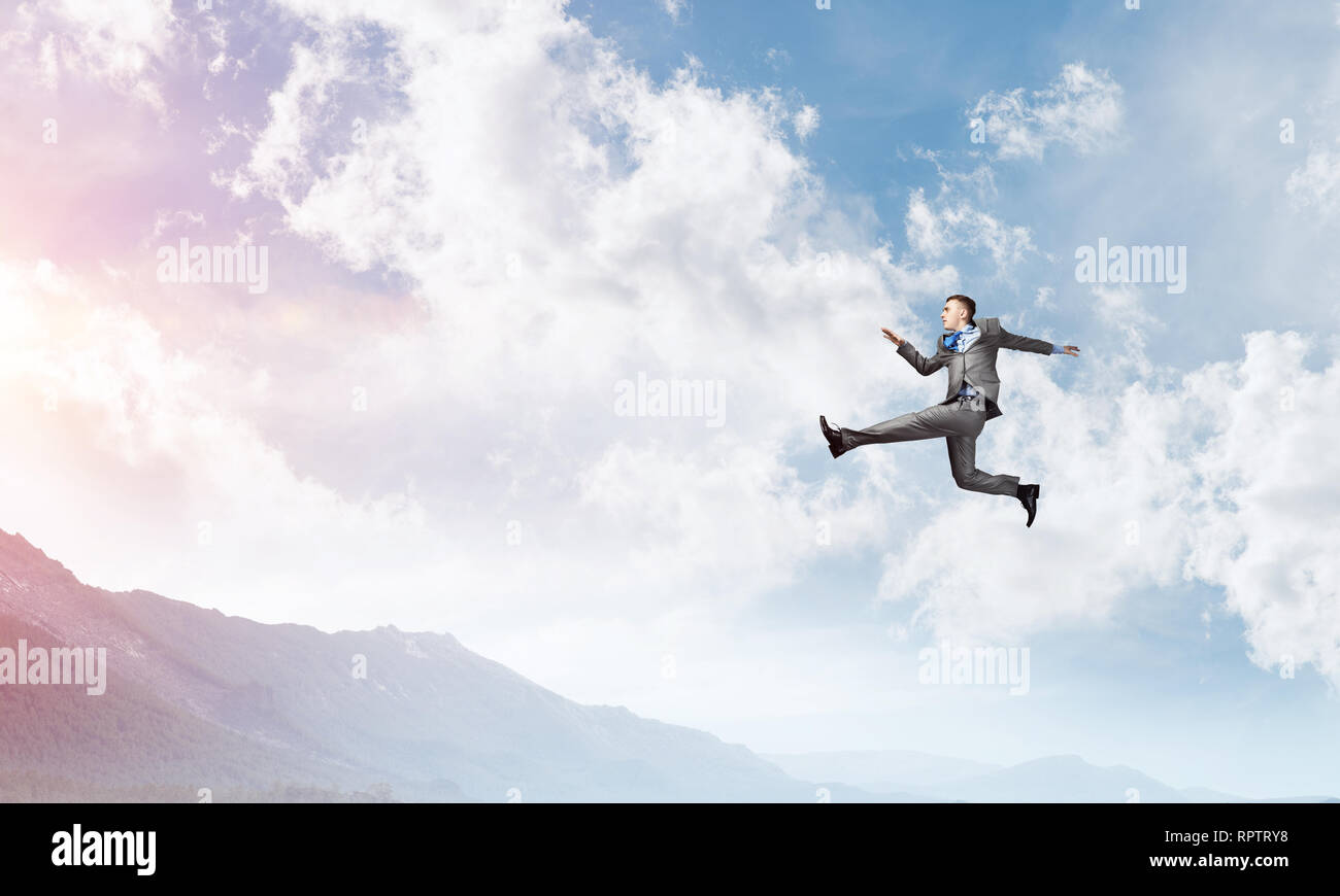 Businessman in suit running in the air as symbol of active life ...
