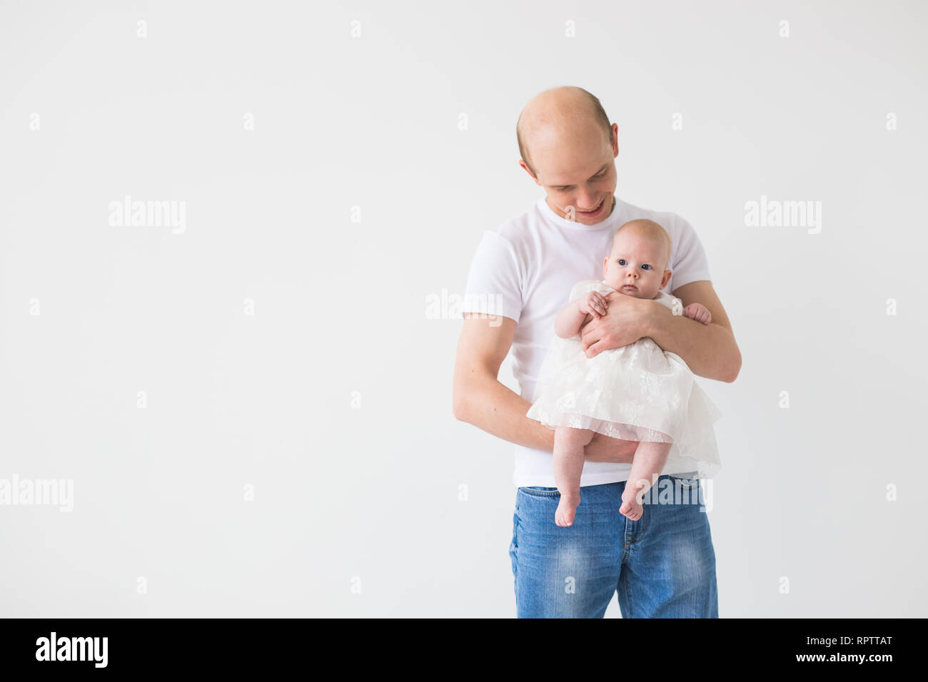 Parenting, family and fatherhood concept - Bald father hugging his ...
