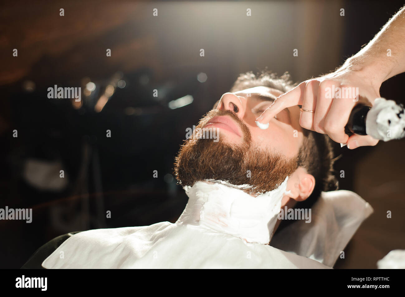 Master cuts hair and beard of men in the barbershop Stock Photo - Alamy