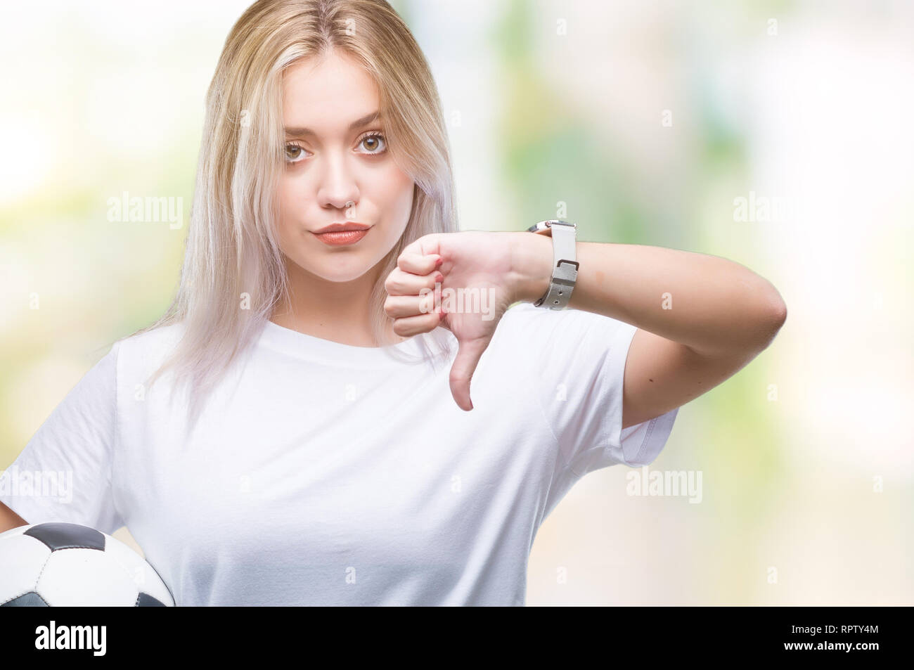 Young blonde woman holding soccer football ball over isolated ...
