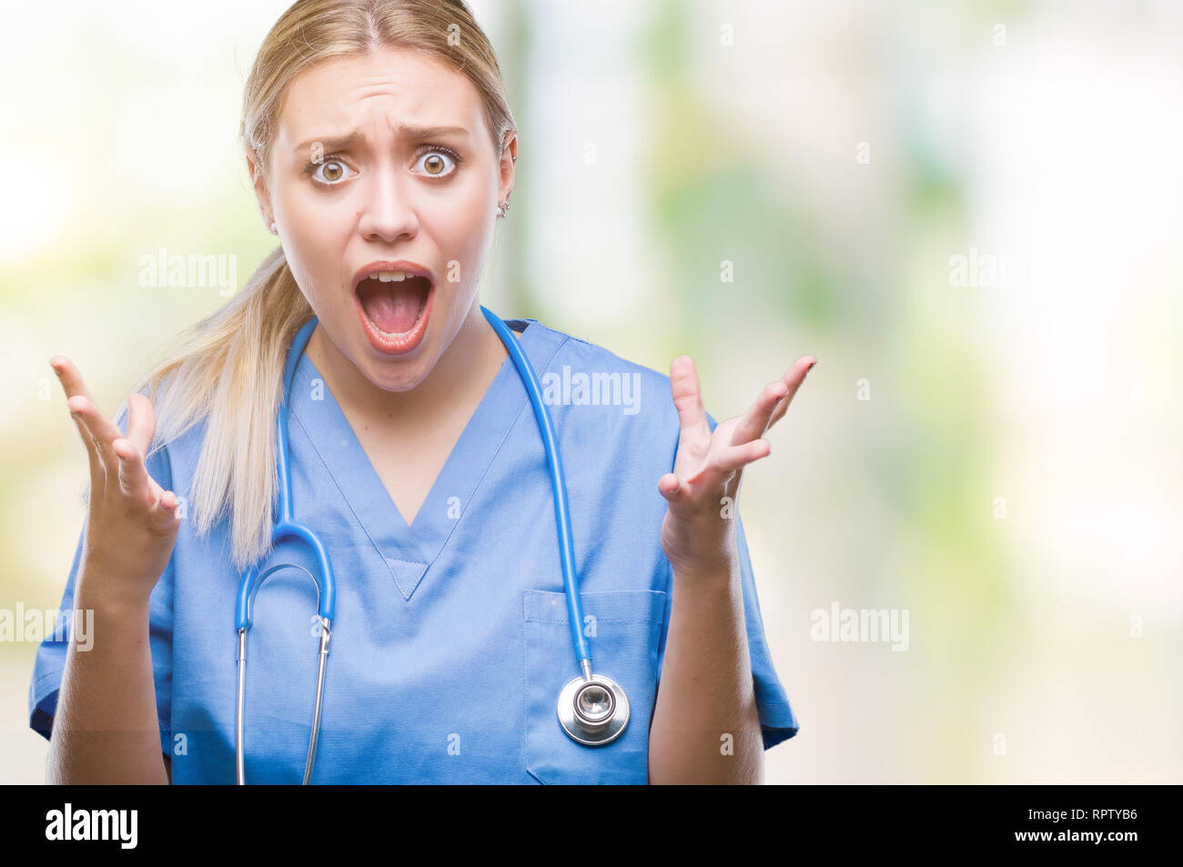 Young blonde surgeon doctor woman over isolated background celebrating ...