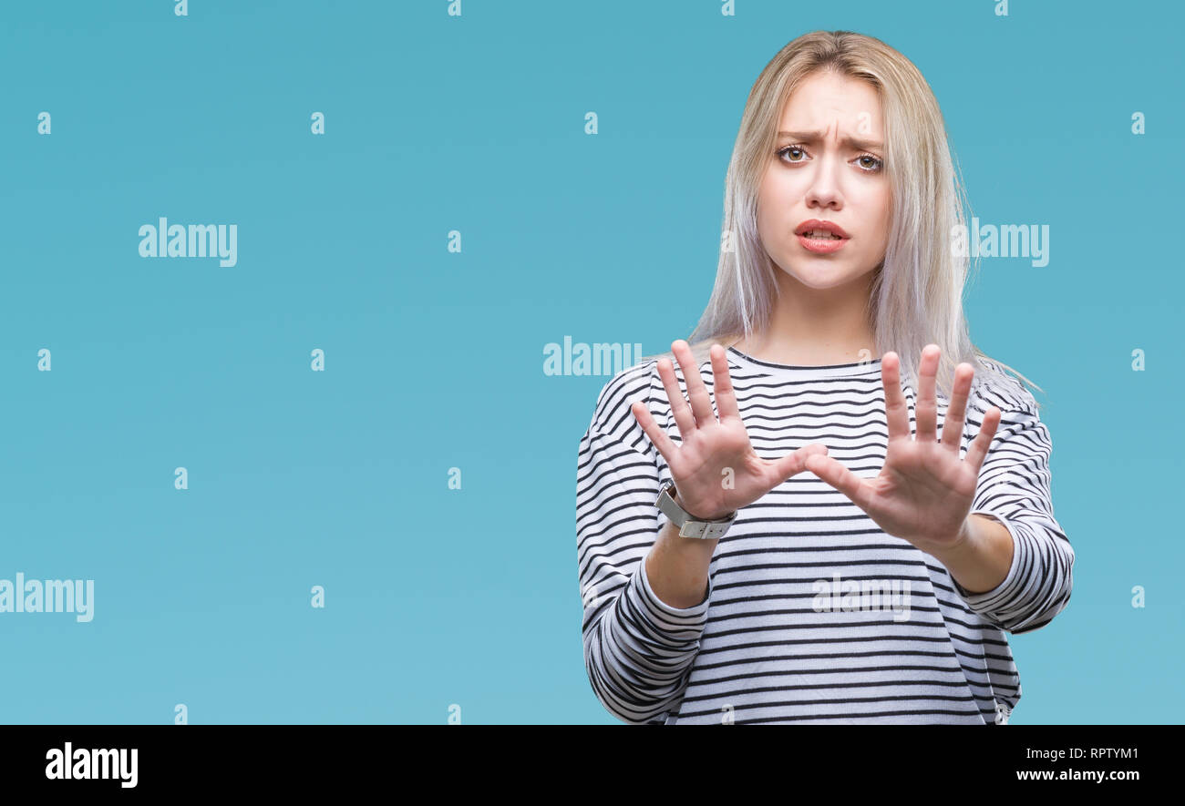 Young blonde woman over isolated background afraid and terrified with ...
