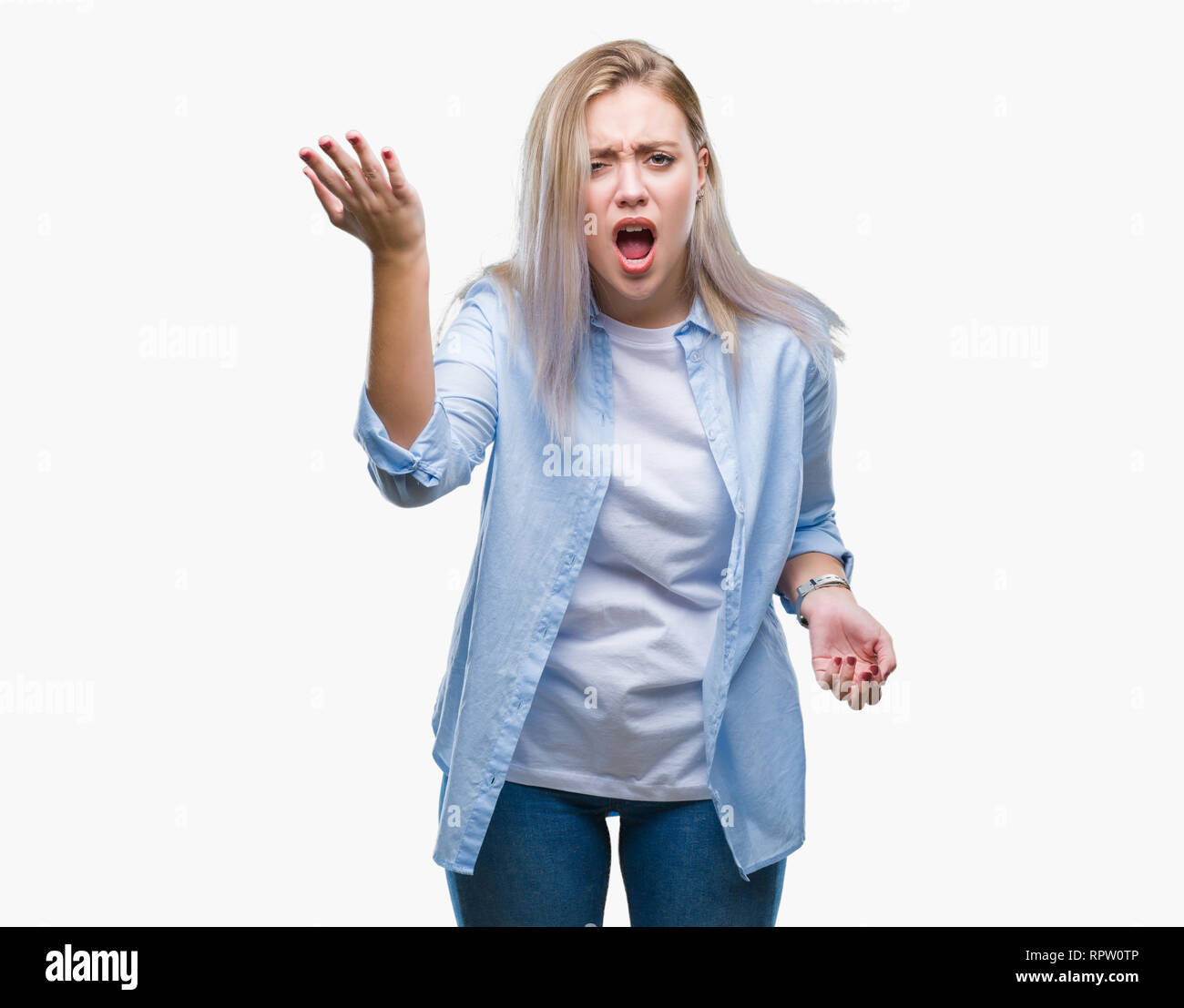 Young blonde woman over isolated background angry and mad raising fist ...