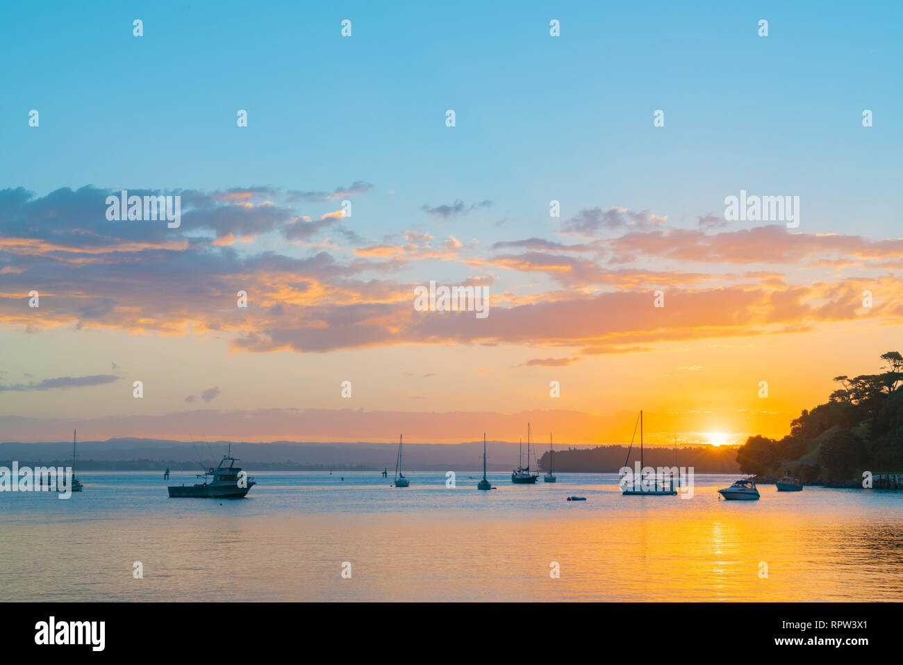 Scenic vista as sun sets over Pilot Bay on Tauranga Harbour with ...