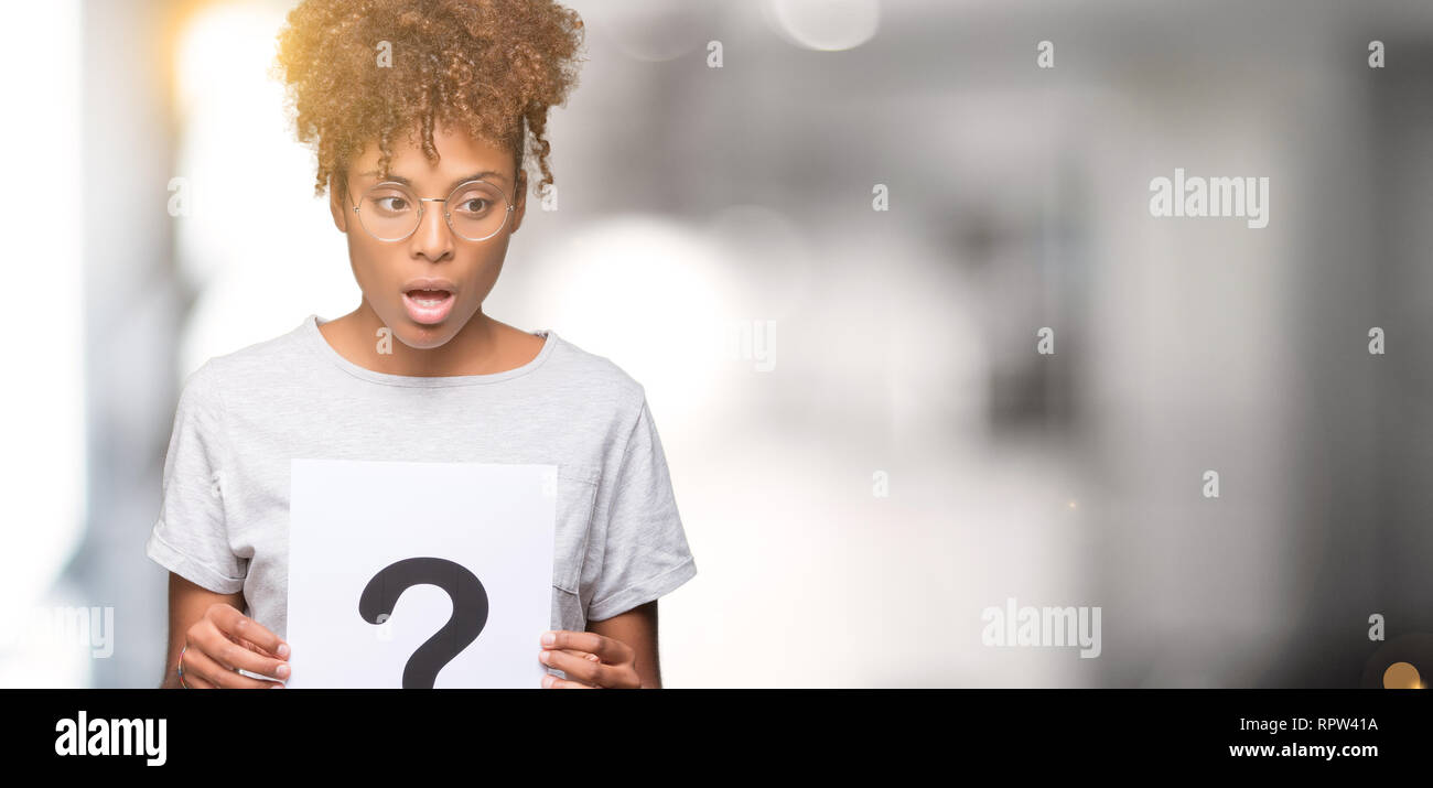Young african american woman holding paper with question mark over ...