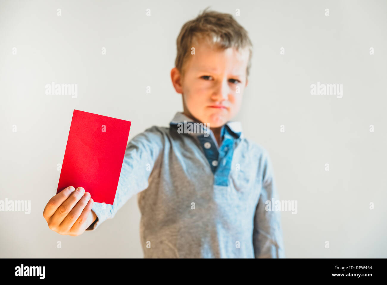 Scared child with red anti bullying card Stock Photo - Alamy