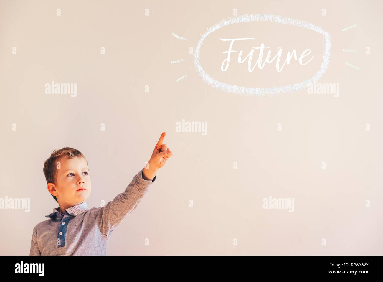 Child pointing with raised hand and finger pointing up, blank space ...