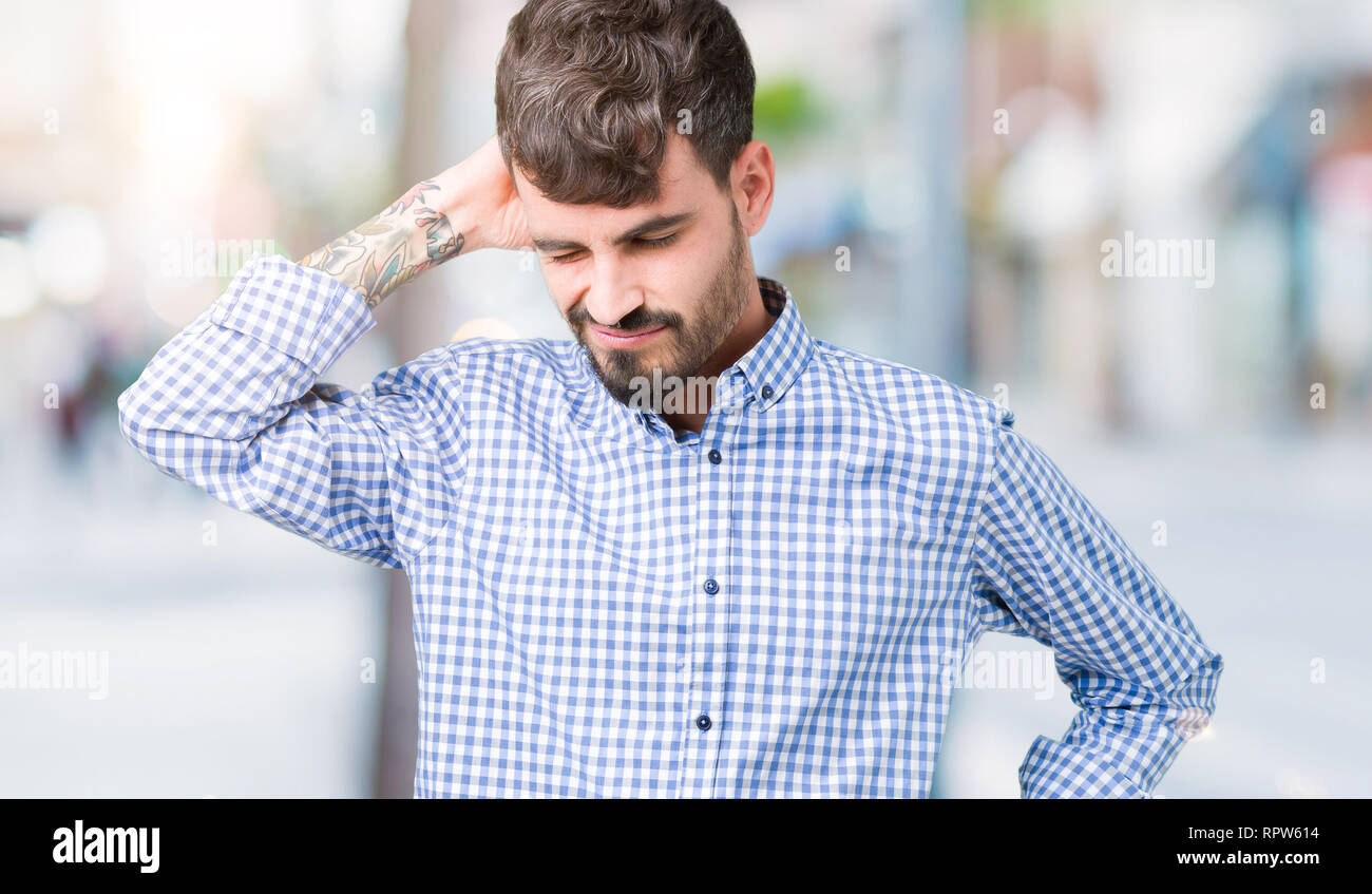 Young handsome business man over isolated background Suffering of neck ...