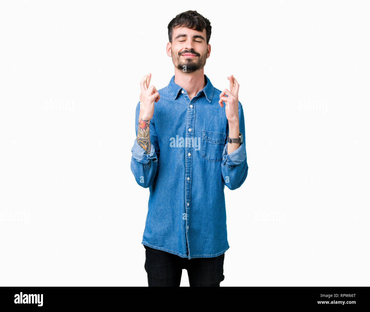 Young hopeful man crossing Cut Out Stock Images & Pictures - Alamy