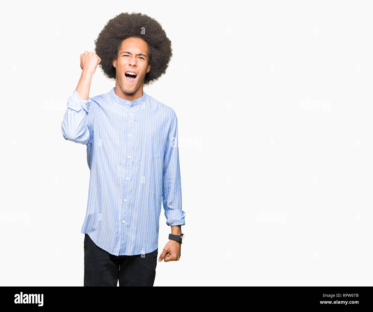 Young african american man with afro hair angry and mad raising fist ...