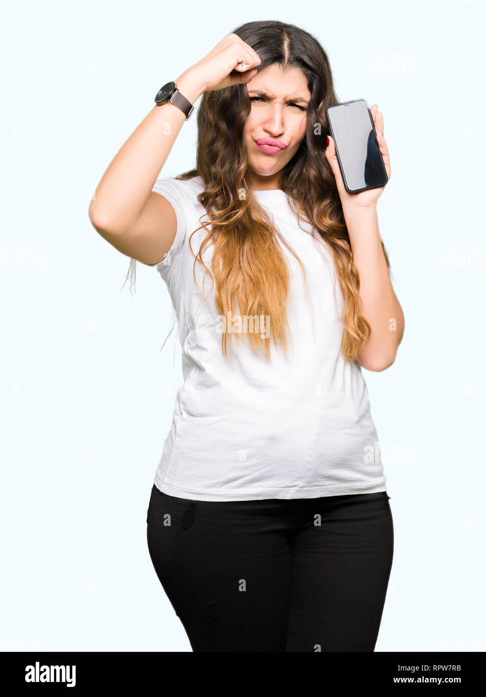 Young adult woman showing smartphone screen annoyed and frustrated ...