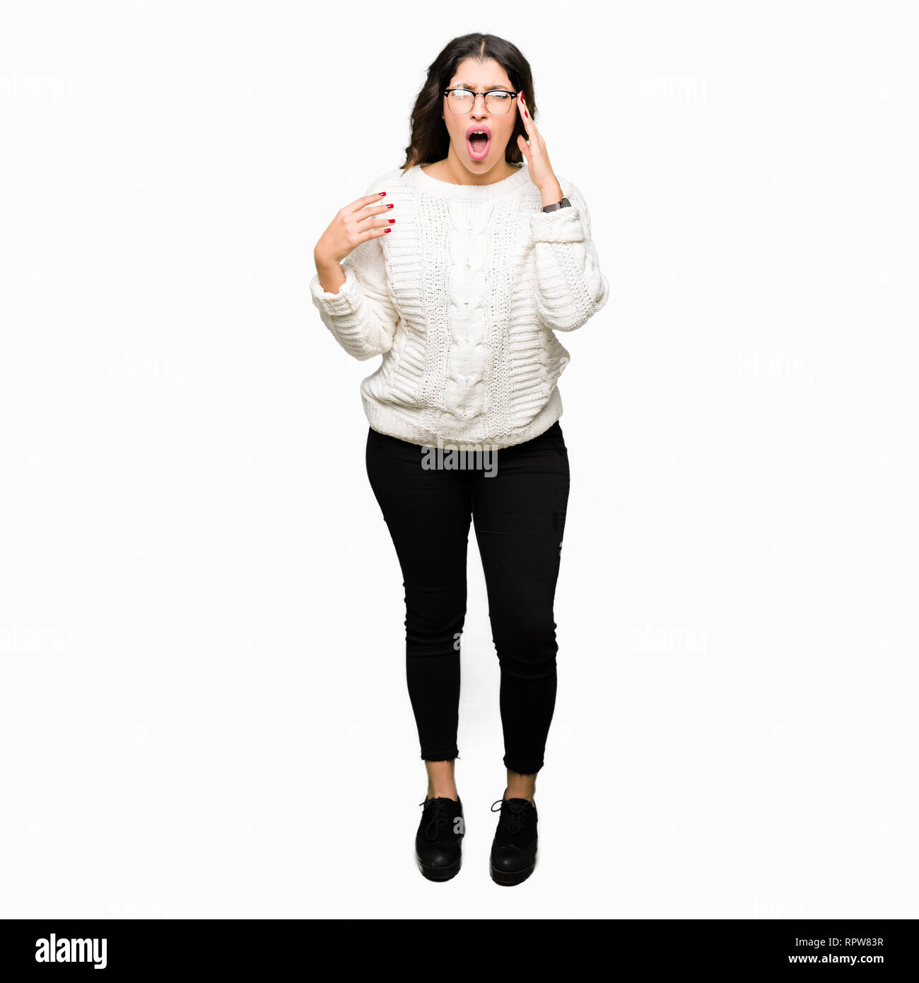 Young beautiful woman wearing glasses afraid and shocked with surprise ...