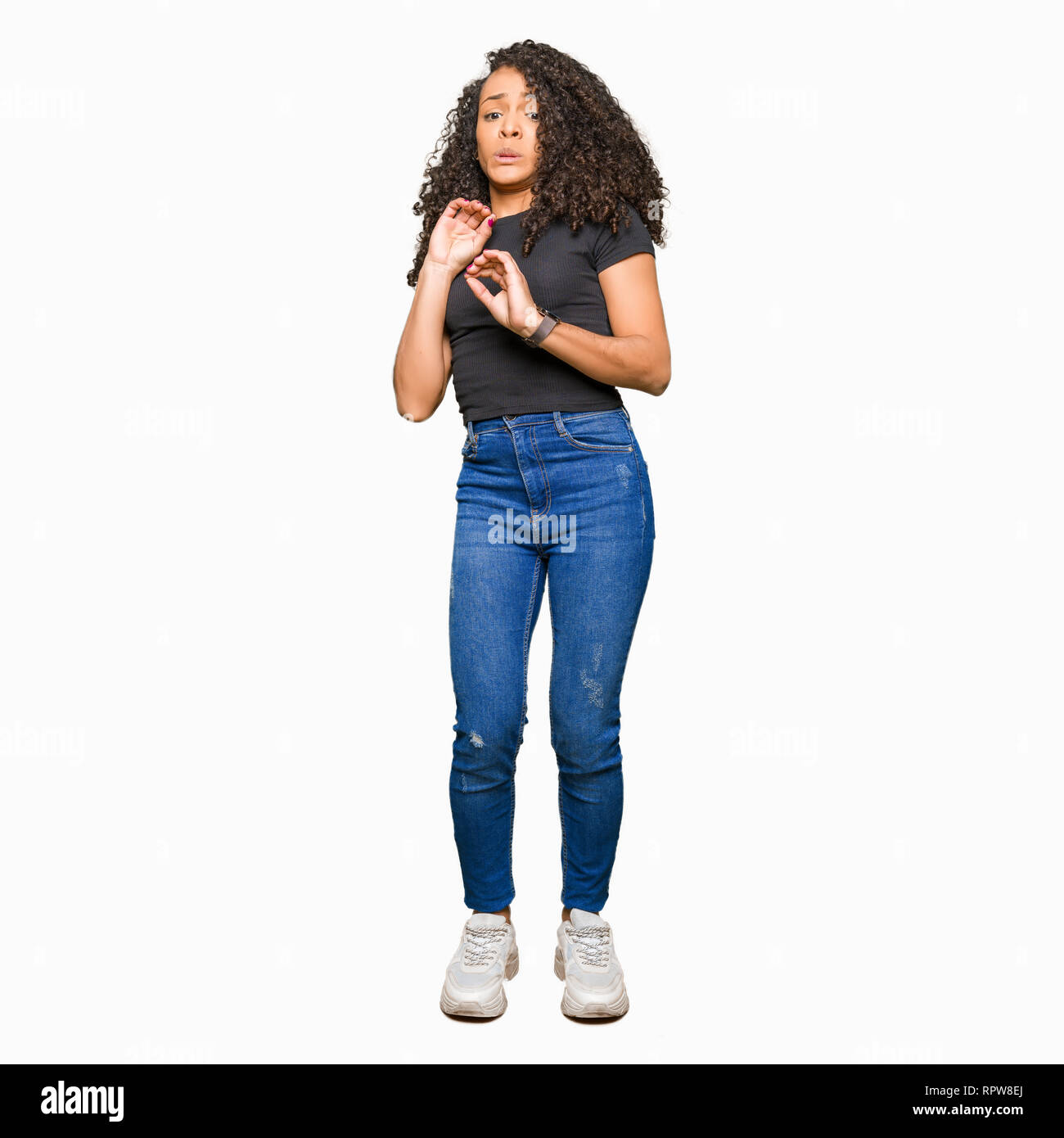 Young beautiful woman with curly hair disgusted expression, displeased ...